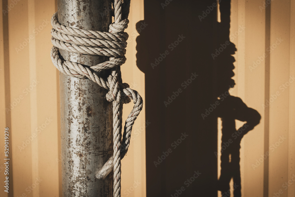 Coarse rope wrapped around wooden pole in vintage color.Blured ...