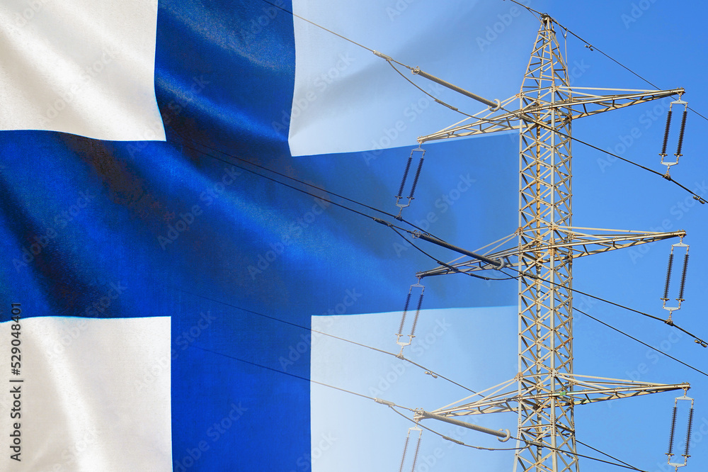 Finland flag on electric pole background. Power shortage and increased energy consumption in ...