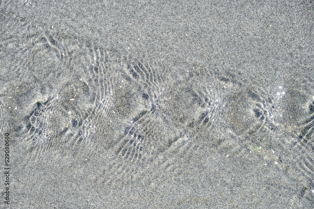 Pattern and texture of moving water over sand, as a nature background ...