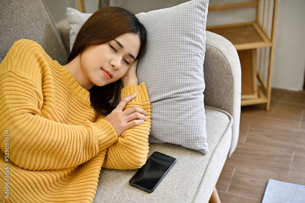 Beautiful clam asian female relaxes sleeping or taking nap on her comfy ...