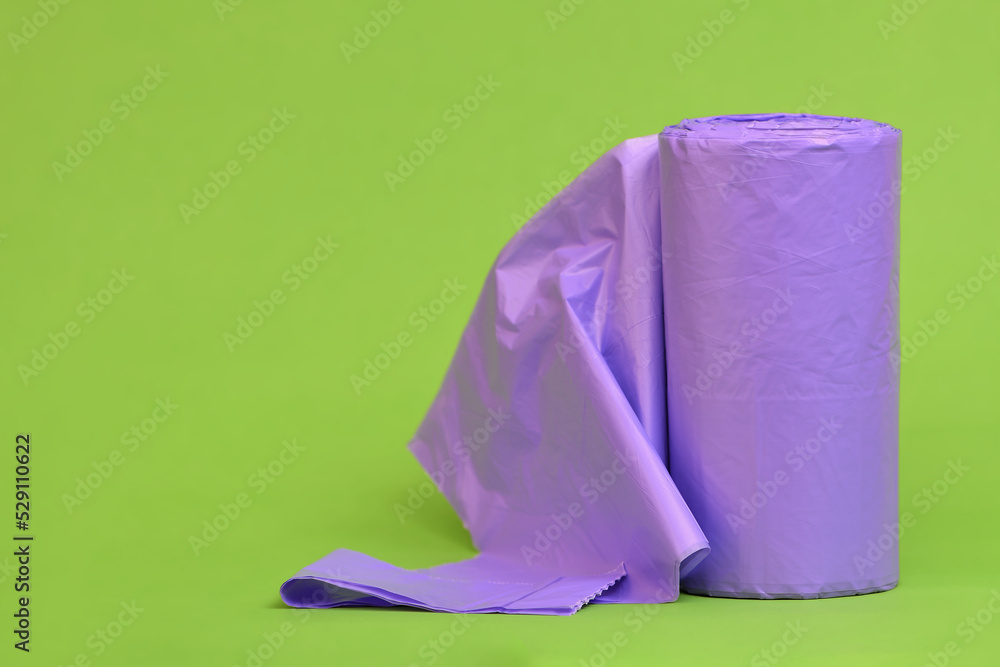 A tightly packed roll of non-recyclable purple rubbish/garbage/trash ...