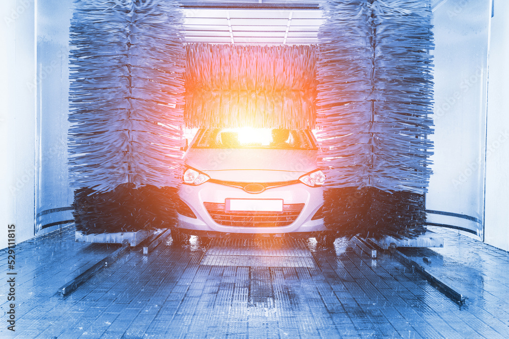 Auto car wash. Auto brush washer clean blue car on automatic carwash ...