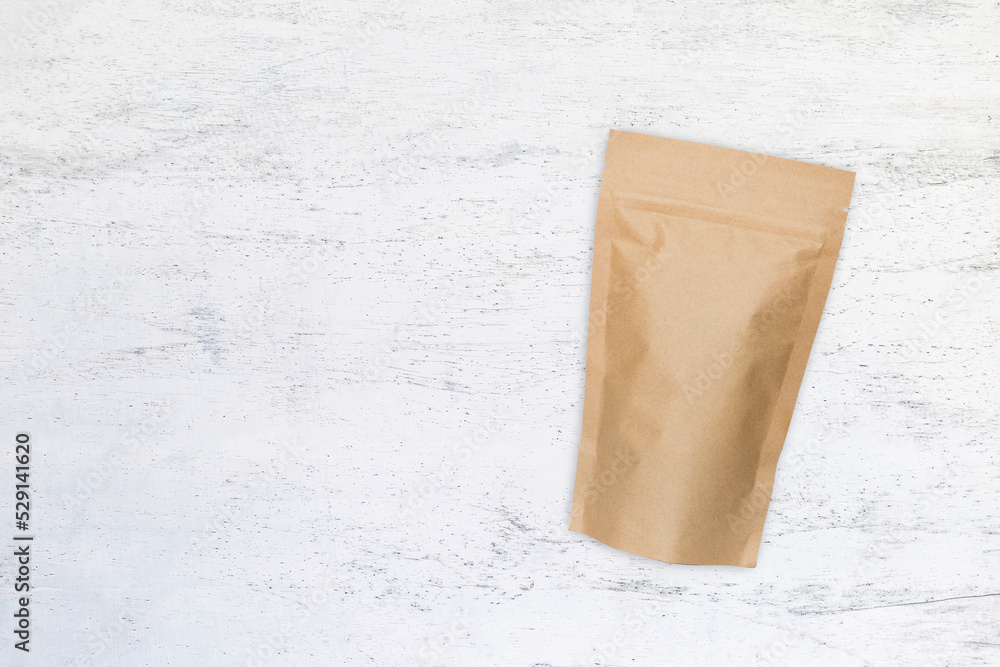 Kraft paper zipper pouch on white wooden background, eco style ...