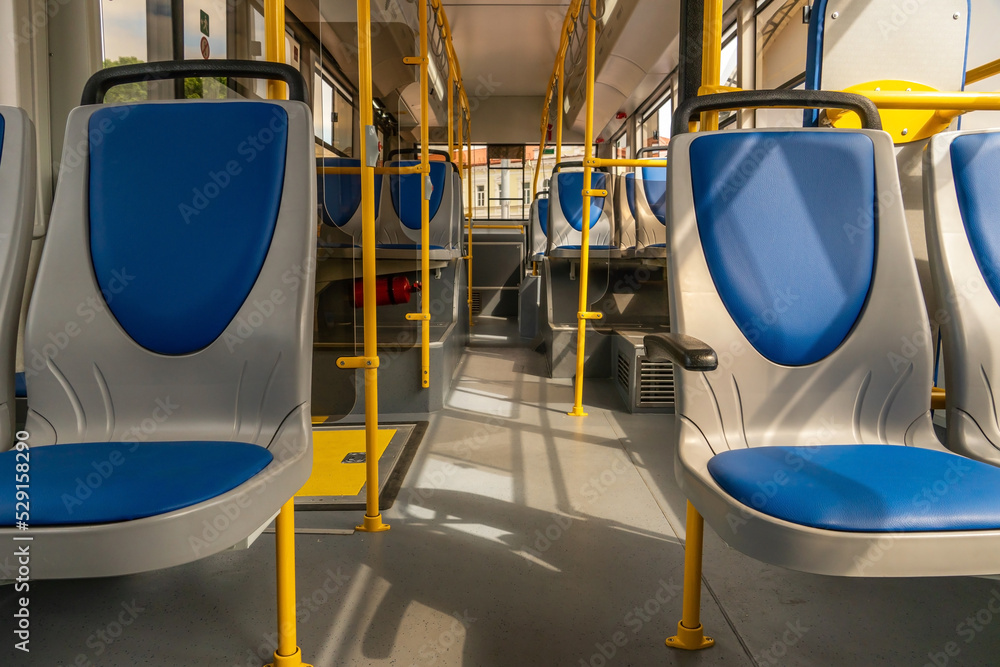 New comfortable seats inside a modern public bus. Seats on the bus for ...