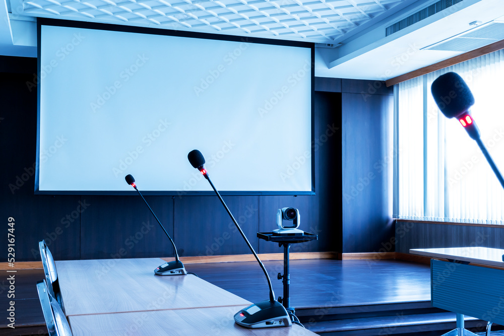 Microphone on table with projector screen background in meeting room ...