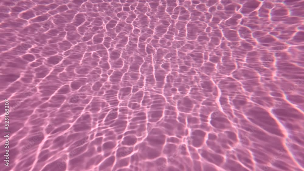 Underwater background, glare of sunlight on the bottom of the pink pool ...