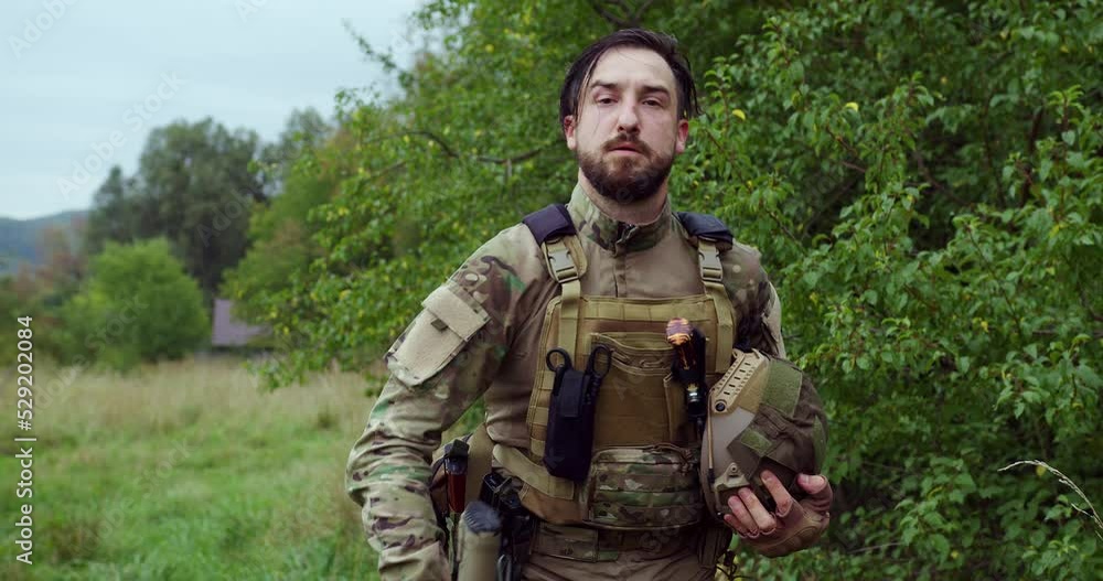 Ukrainian soldier speaks and laughs looks into the camera and raises ...