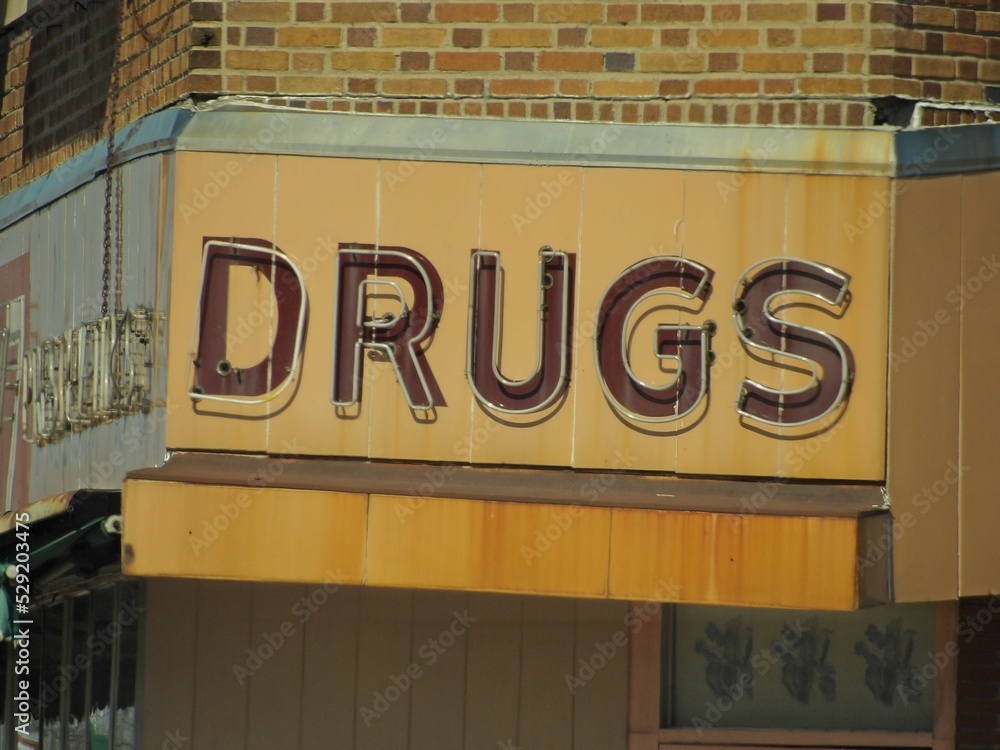 Word Drugs on a yellow brick wall. Old pharmacy signage in Saint Paul ...