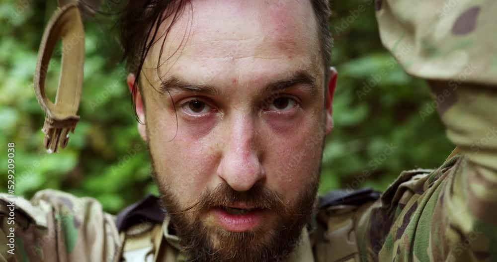 the wet, sweaty face of a soldier. look into the camera. Ukrainian ...
