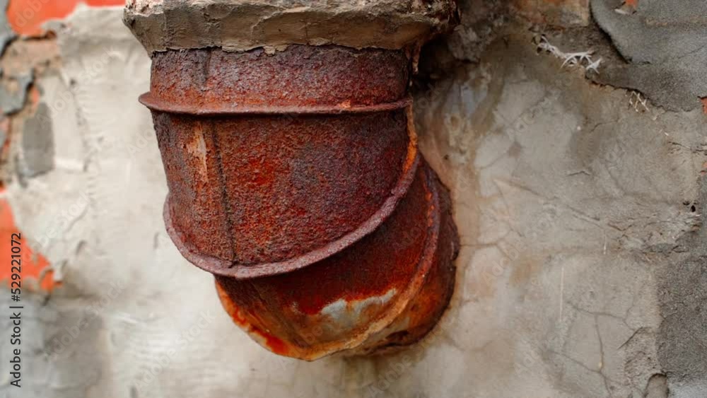 Old rusted smoke exhaust pipe from the heating stove. Corner connection ...