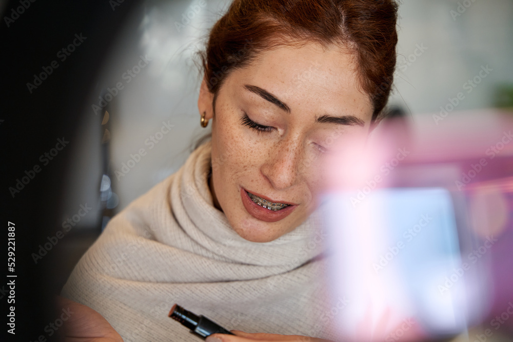 young influencer woman sitting in the dining room and in a live ...