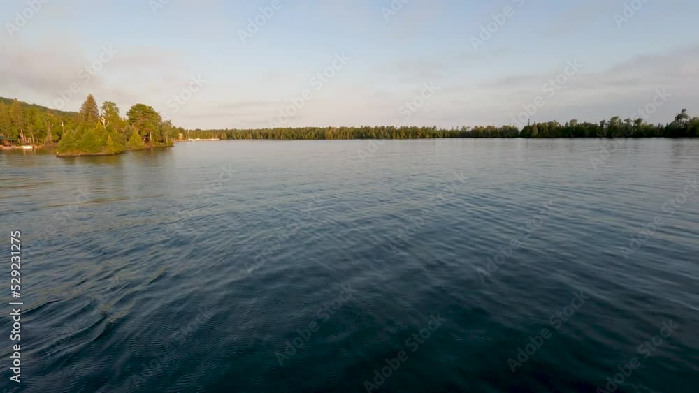 Gliding through the deep blue lake water, taking off from the Northern ...