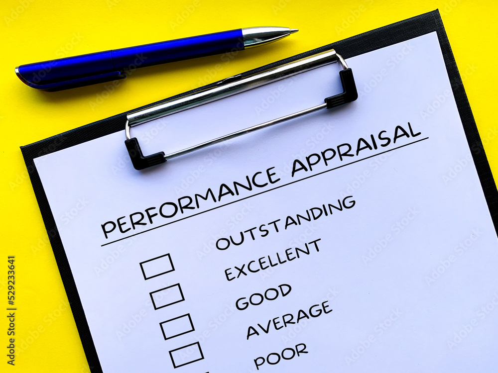 Top view of performance Appraisal checklist on clip board with yellow ...