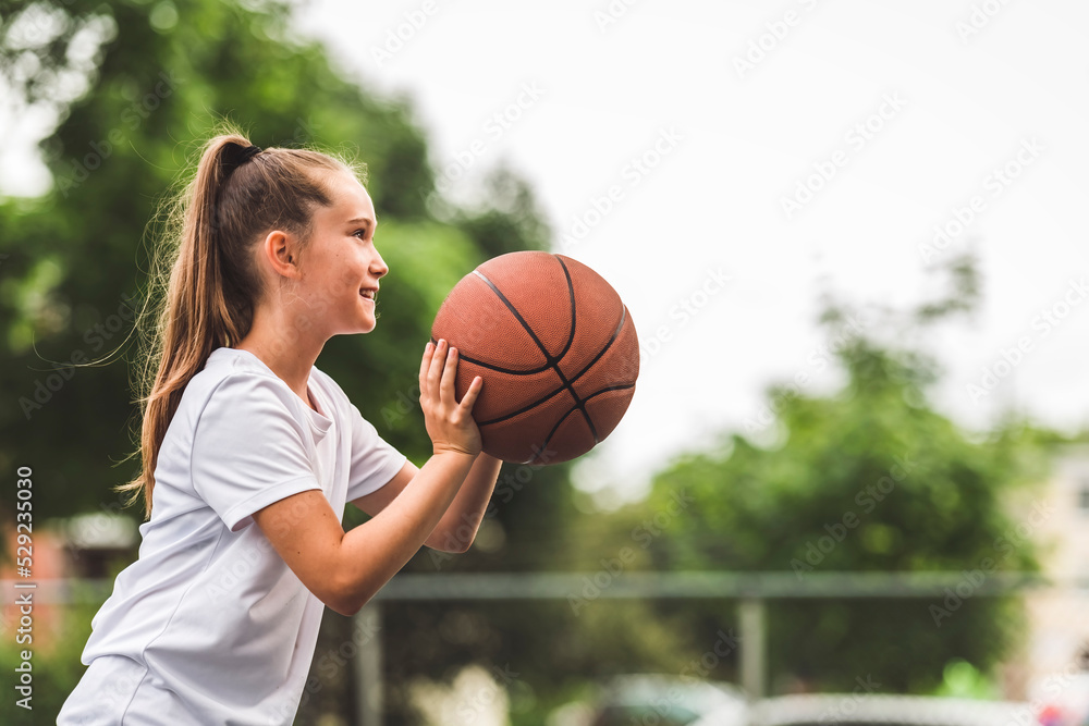 portrait of a kid girl playing with a basketball in park Stock Photo ...