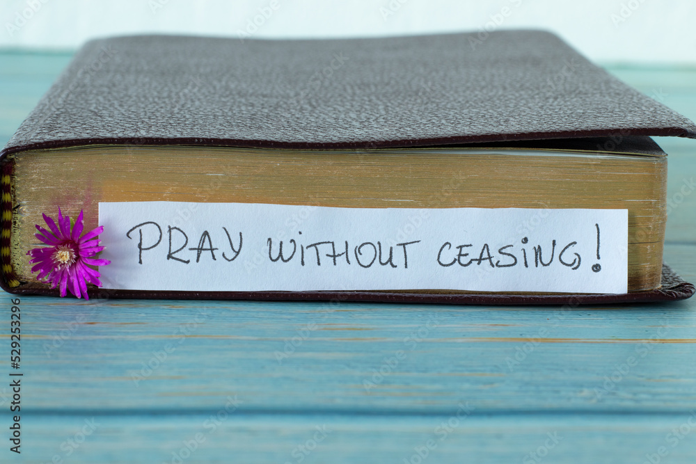 Pray without ceasing, a handwritten text on a note with a purple flower ...