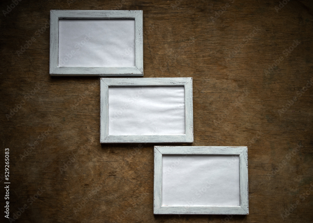 Three wooden horizontal frames on the wall in vintage style. A white ...