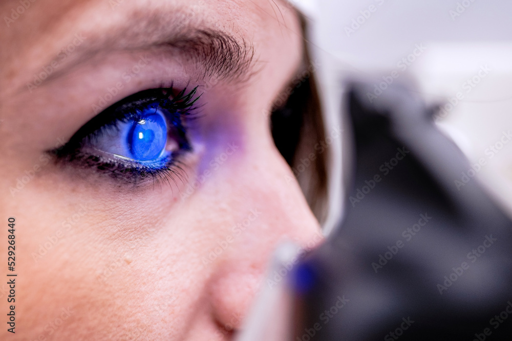 Woman during ocular tonometry procedure Stock Photo | Adobe Stock