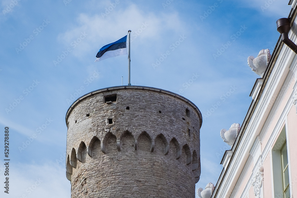 Estonian flag on top of old medieval tower "Pikk Herman" in Tallinn old ...