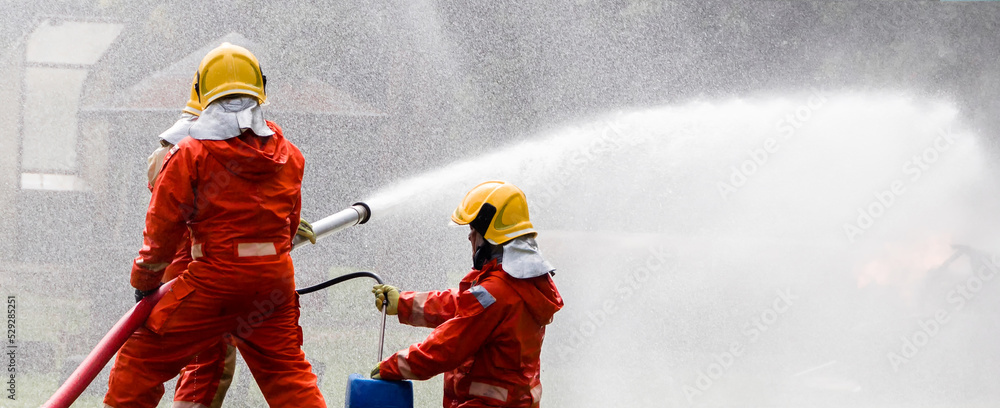 Firefighter Concept. Fireman using water and extinguisher to fighting ...