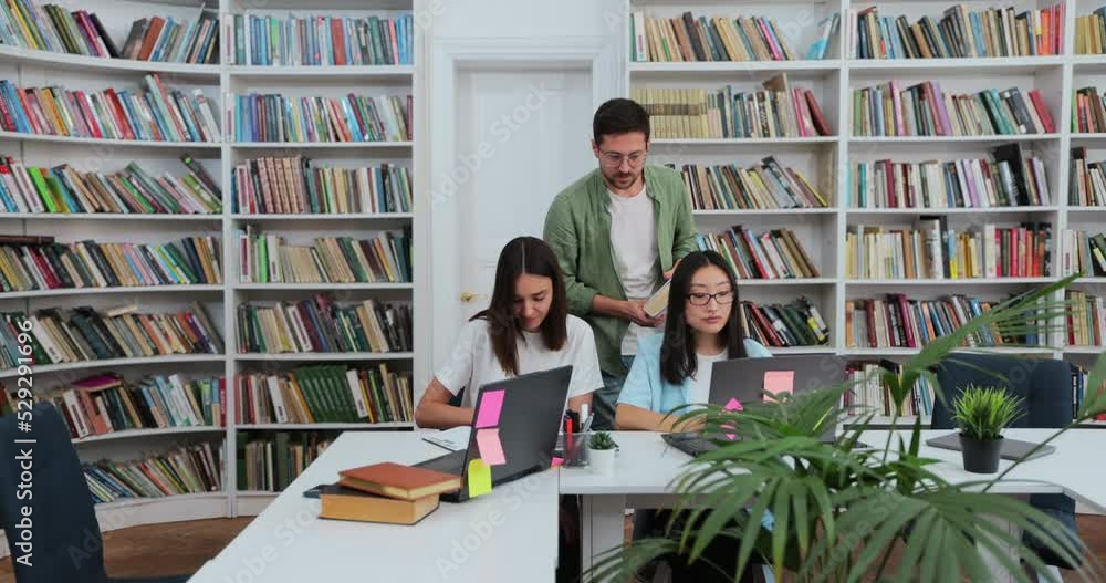 Students team study together using laptop prepare for exam in library ...