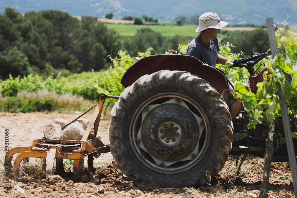 Side view of farmer sitting on tractor at farm Stock Photo | Adobe Stock