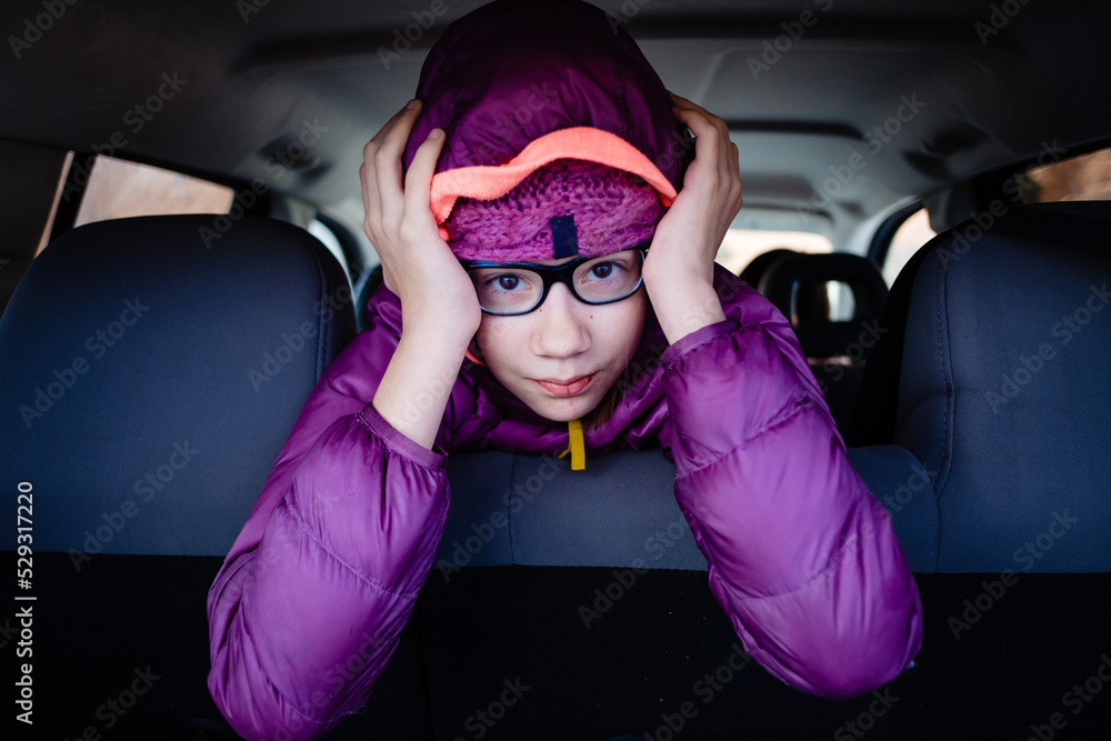 girl wearing winter coat in a car Stock Photo | Adobe Stock