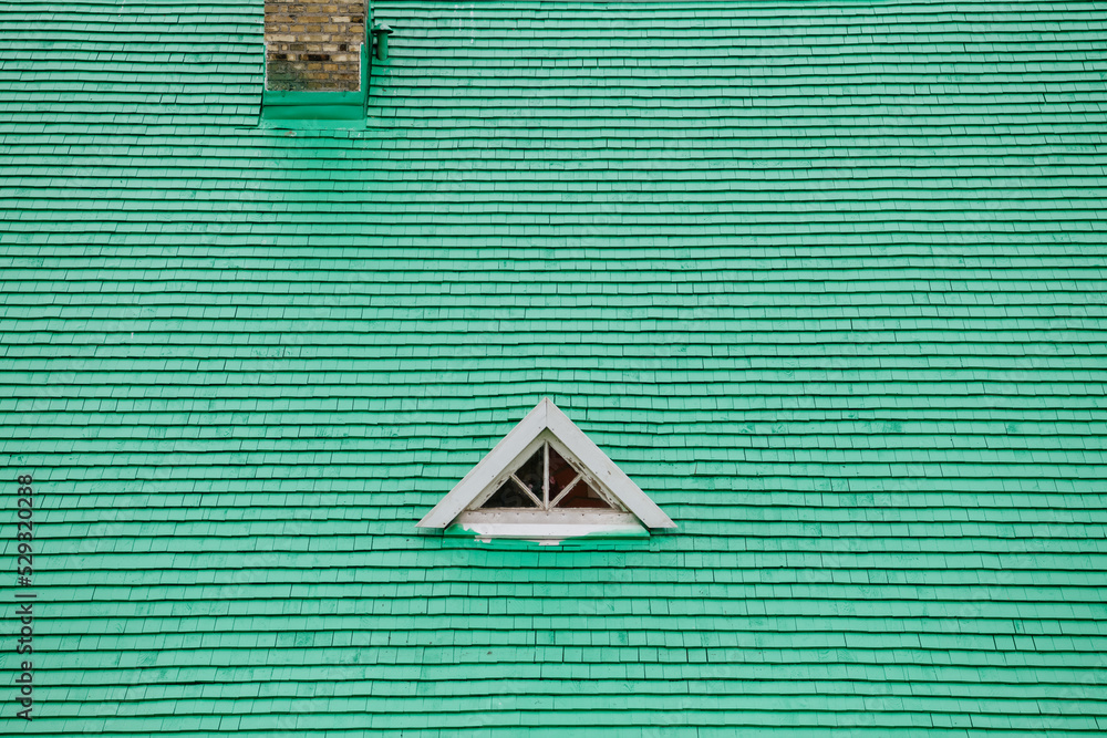 A green roof with a triangular window Stock Photo | Adobe Stock