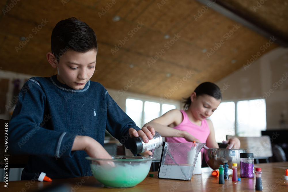 Tweens making slime with glue and glitter Stock Photo | Adobe Stock