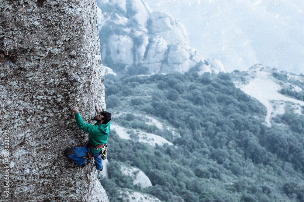 Climber sending a difficult route on sport climbing zone in Montserrat ...