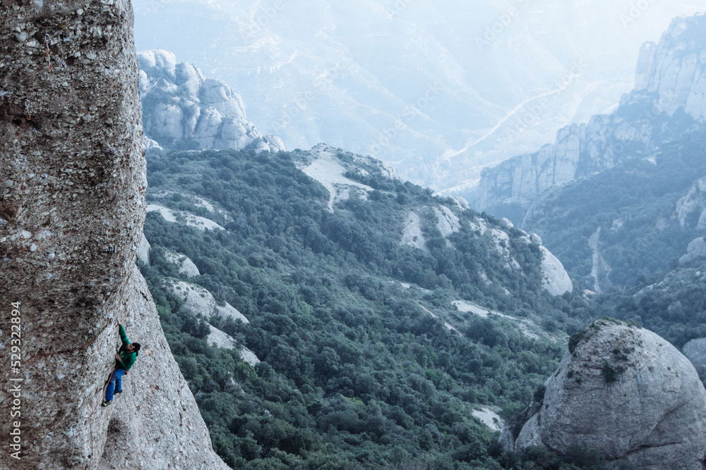 Climber sending a difficult route on sport climbing zone in Montserrat ...