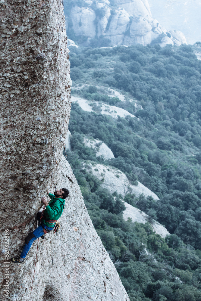 Climber sending a difficult route on sport climbing zone in Montserrat ...