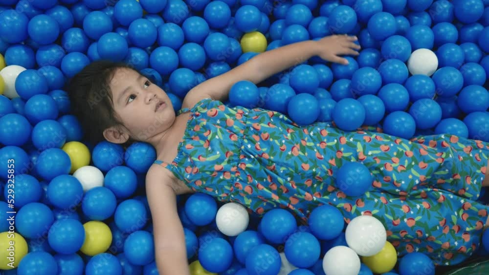 Happy Asian child woman having fun on entertainment center inflatable ...
