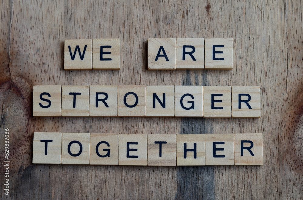 we are stronger together text on wooden square, inspiration and ...