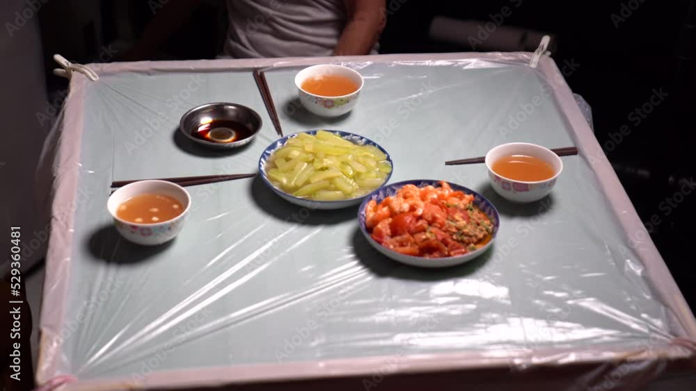 eating with chopsticks on a white table. two Asian man eating a meal ...