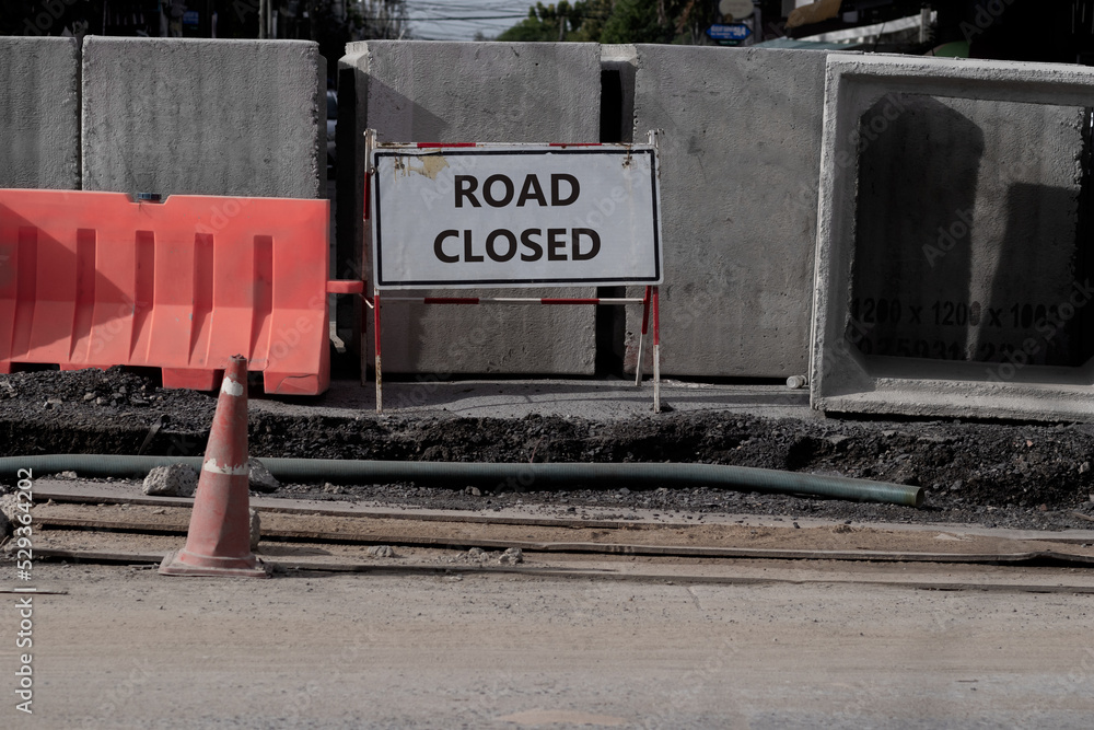 Under construction street with ROAD CLOSED word shown on white traffic ...