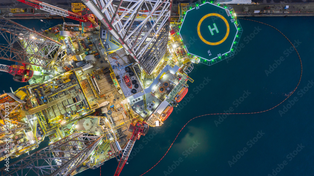 Aerial view jack up rig under maintenance at night, Aerial view of jack ...