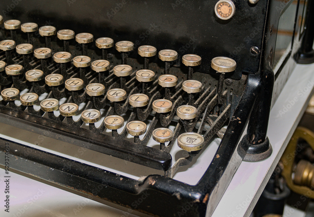 Old typewriter keyboard close up with circular keys with alphabet ...