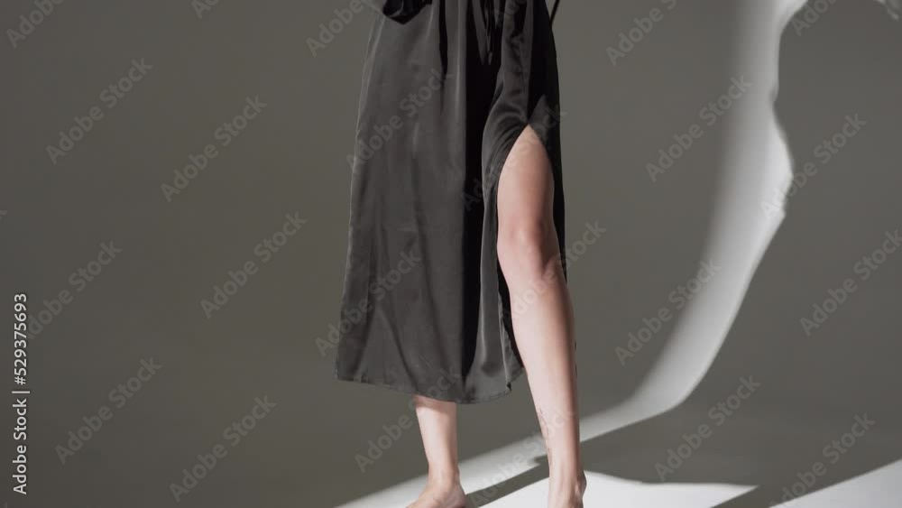 Stylish fashion model posing in black robe and mirrored headdress in ...