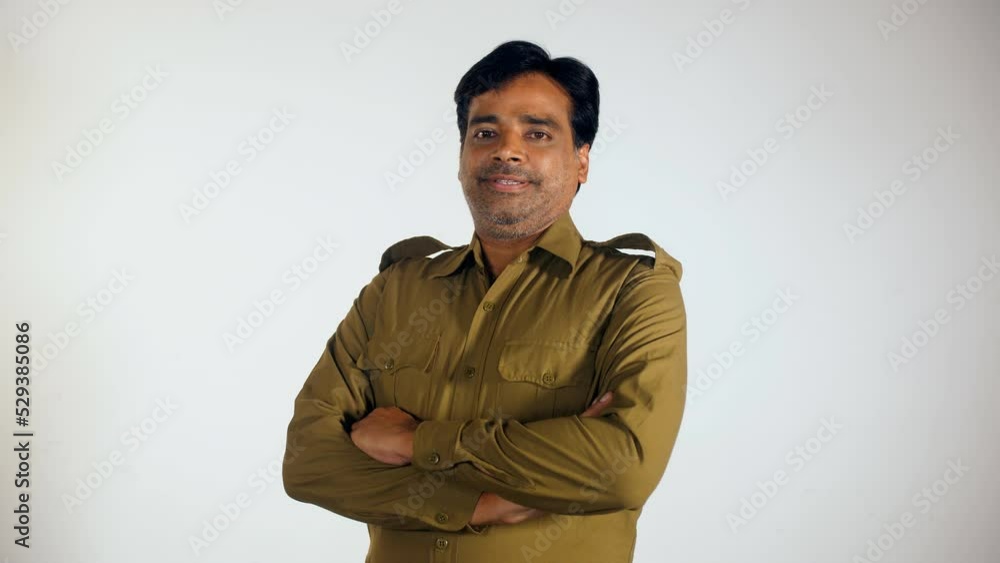 An Indian autorickshaw driver standing with crossed arms and posing for ...