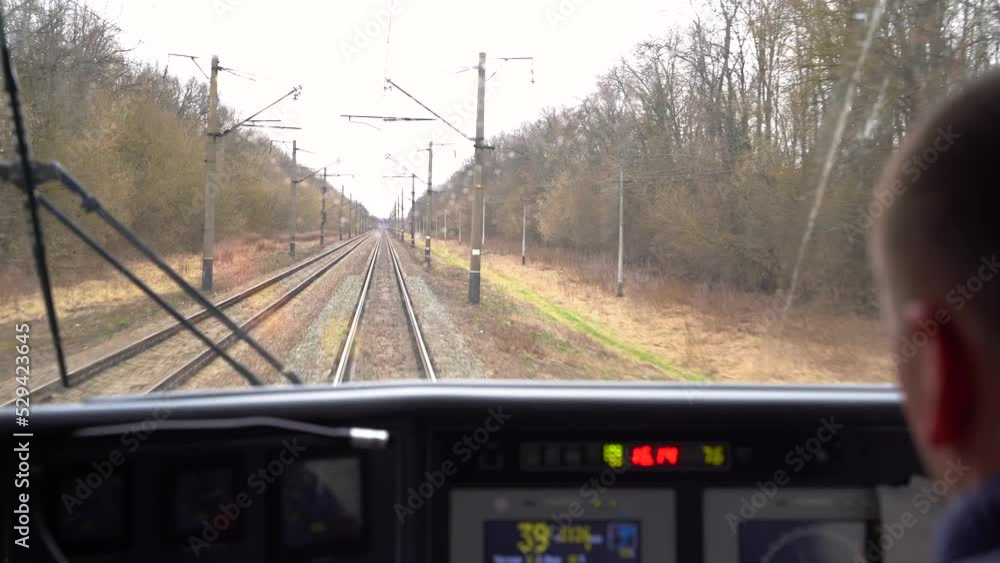 Back view of male train driver sitting in cabin. passenger train ...