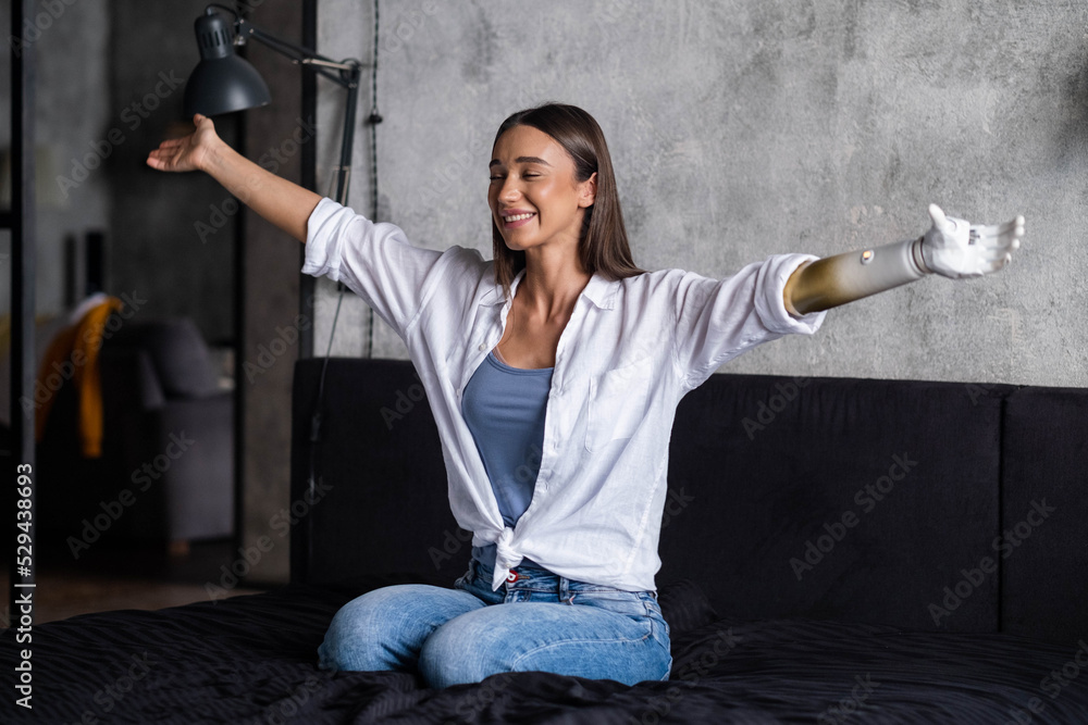 Portrait happy woman with prosthetic arm, girl with disability relaxing ...