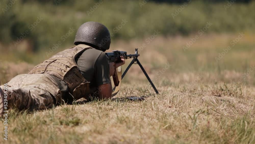 Unloading machine gun, soldier lying with gun, Army war concept, ready ...