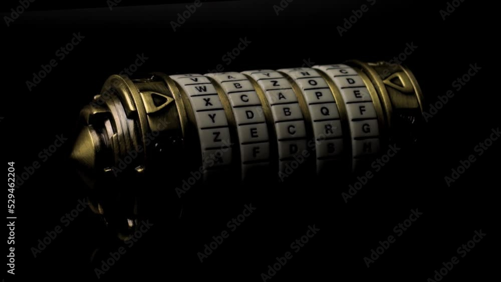 4k video of a metal cryptex secured by letter combination lock spinning ...