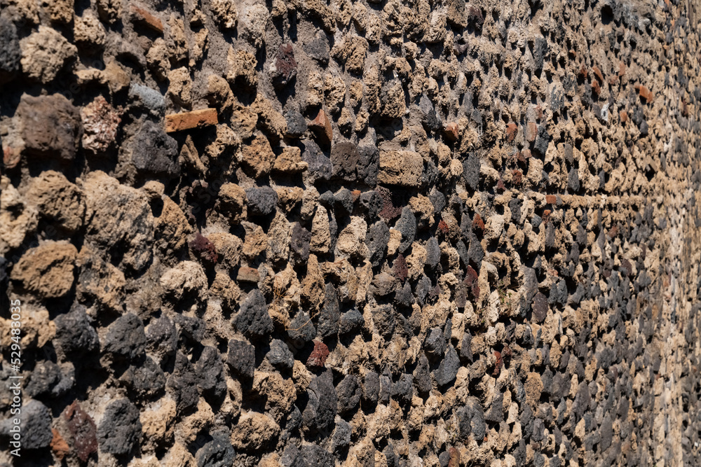 Brick quarry stones of a facade wall in Pompeii. Building made by roman ...
