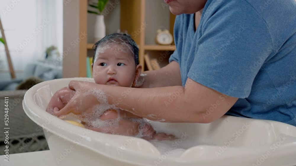 4K, Asian baby girl, taking a bath, he bathes in a bubble bath, with a ...