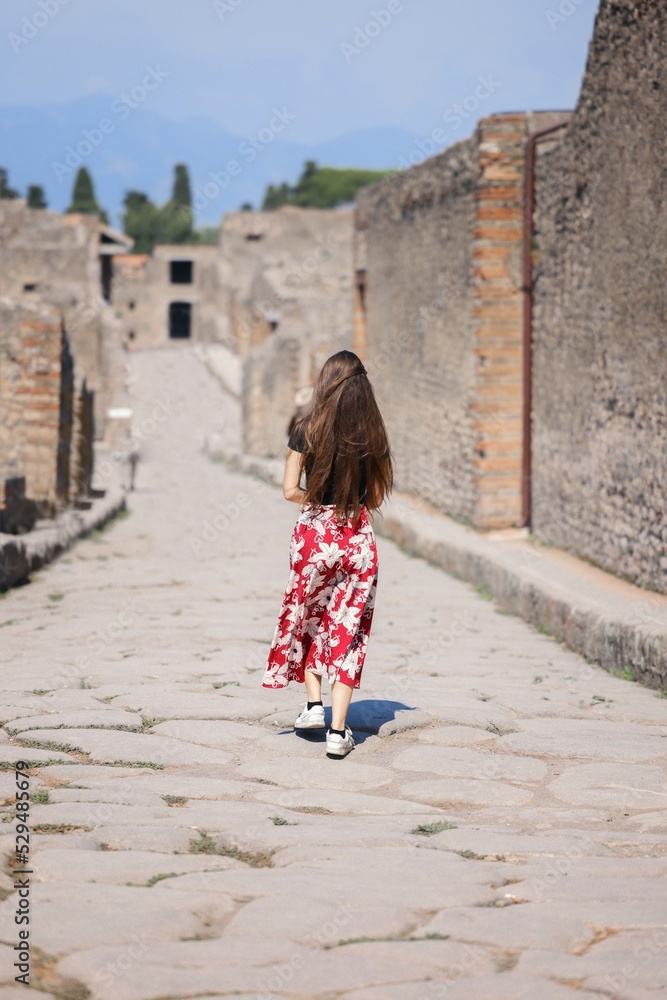 Travel photo of woman amongs some ancient ruins Stock Photo | Adobe Stock