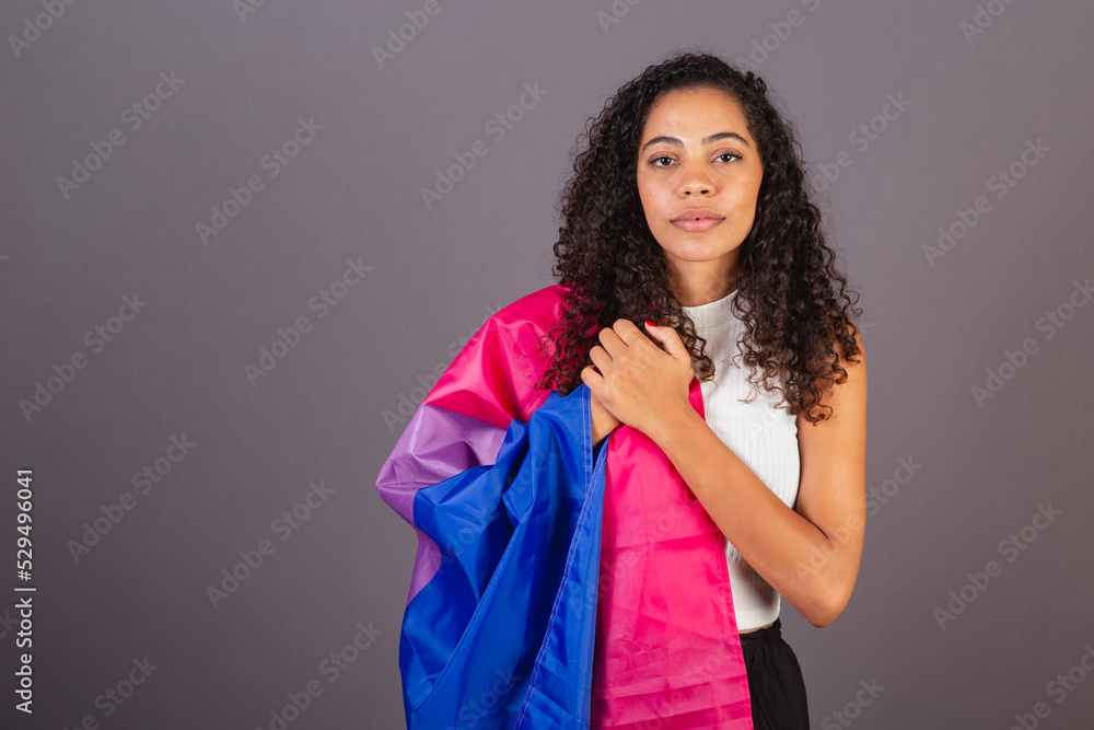 Young Brazilian black woman, bisexual flag on her chest singing anthem ...