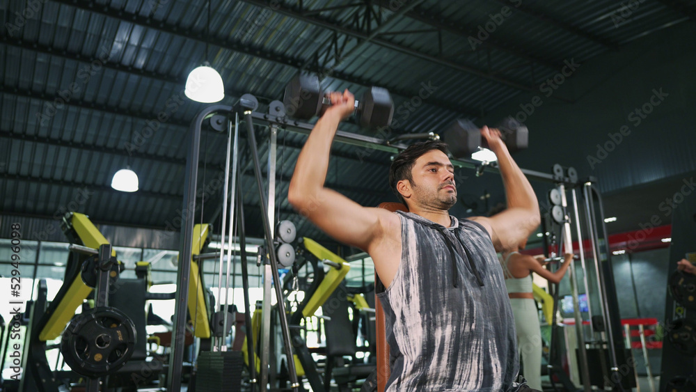 Asian athlete man in sportswear doing seated shoulder press with ...