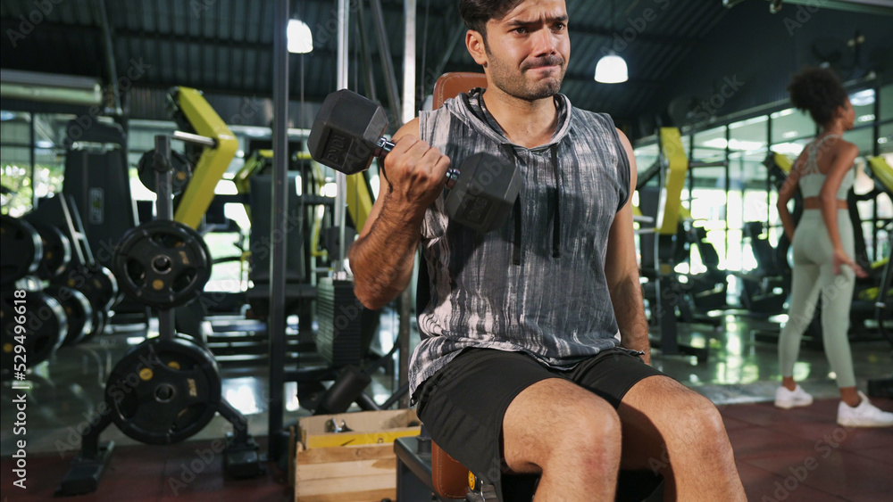 Asian athlete man in sportswear doing seated bicep arm curl with single ...