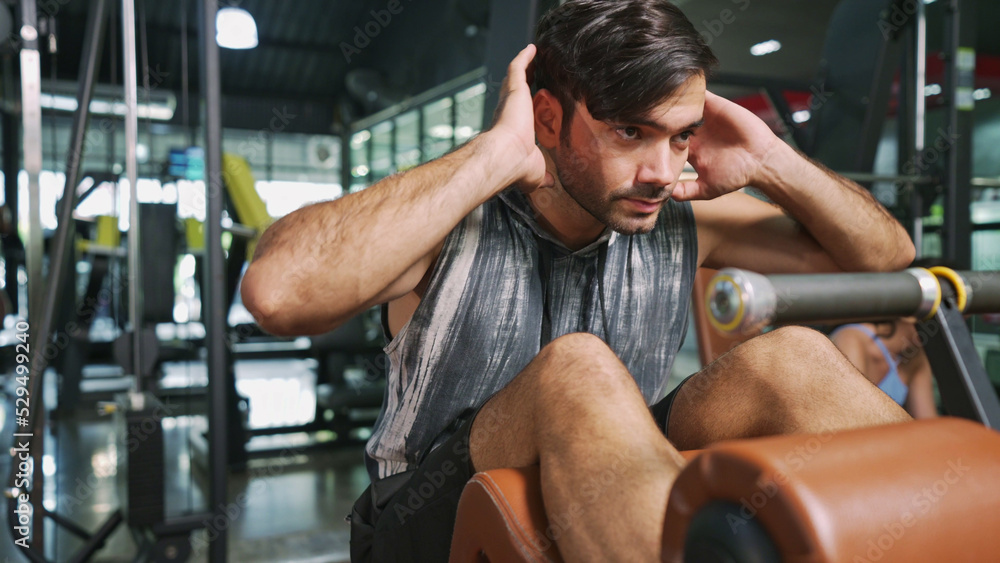 Foto de Portrait of Asian male bodybuilder lying down sit-up bench and ...